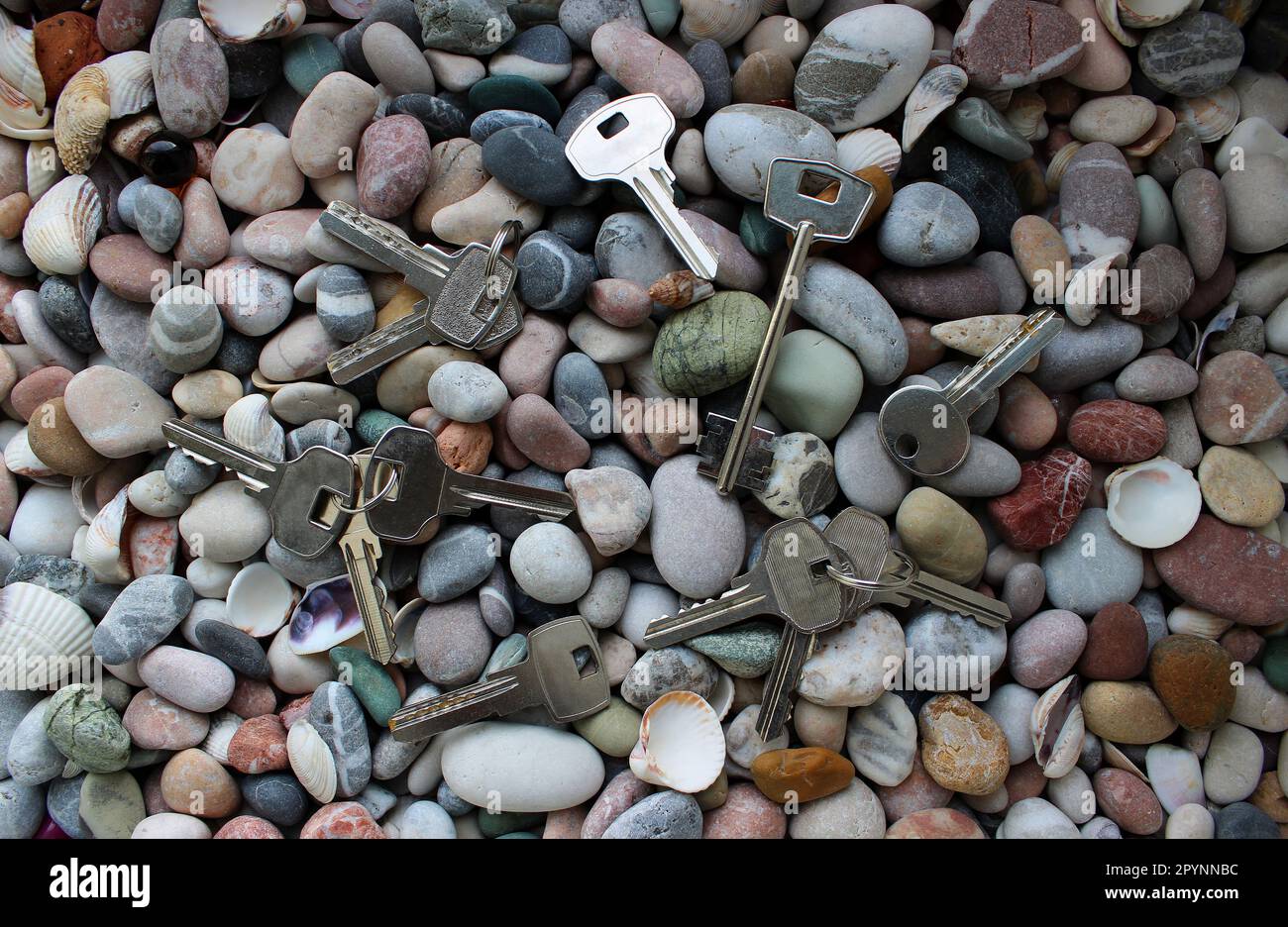 Lost metal keys scattered on smooth stones texture background Stock ...