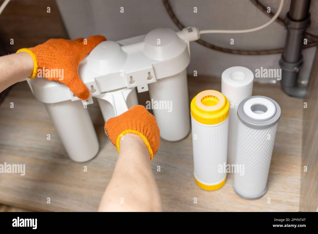 Plumber installs change water filter hi-res stock photography and ...