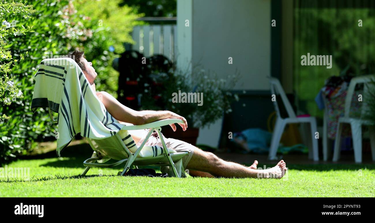 Man sunbathing in yard hi-res stock photography and images - Alamy