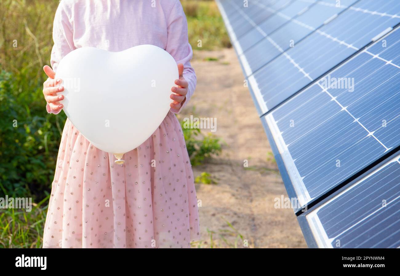 Close up view of girl child holding white empty heart shape balloon ...