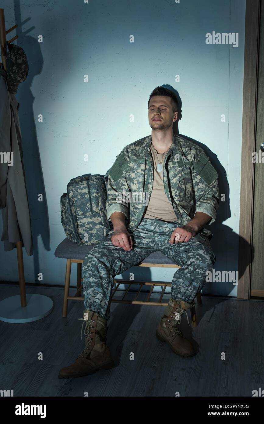 Lonely military veteran with post traumatic stress disorder sitting in ...