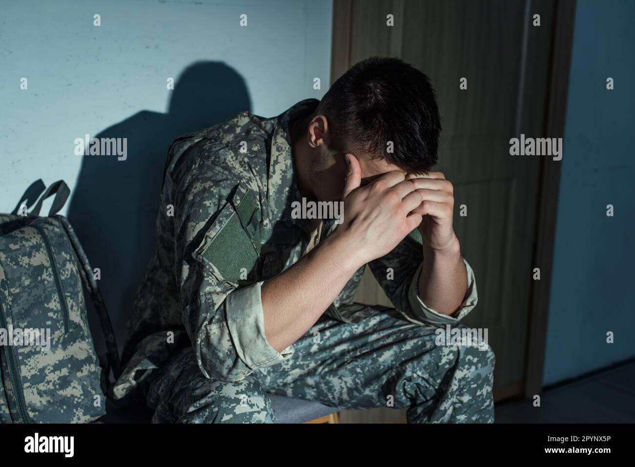 Lonely military veteran with post traumatic stress disorder sitting in ...