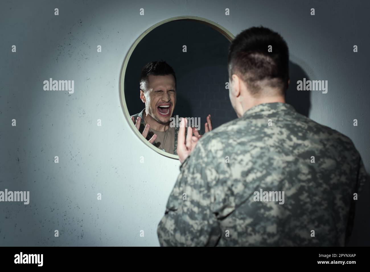 Angry military veteran screaming near mirror while suffering post ...