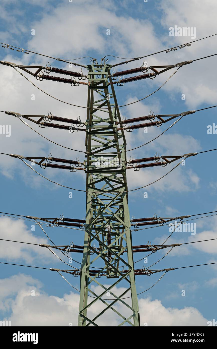 Power line pylon in front of sky with clouds Stock Photo - Alamy