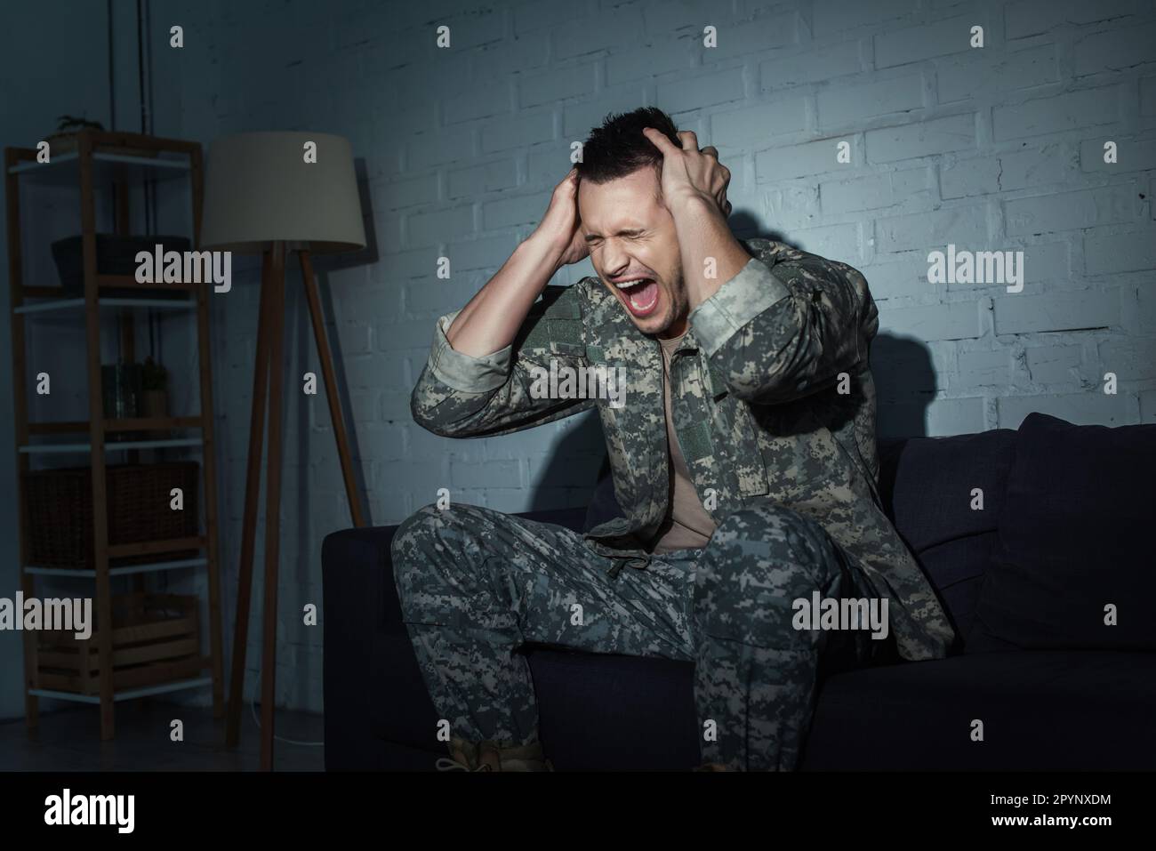 Irritated military veteran screaming while suffering from emotional ...