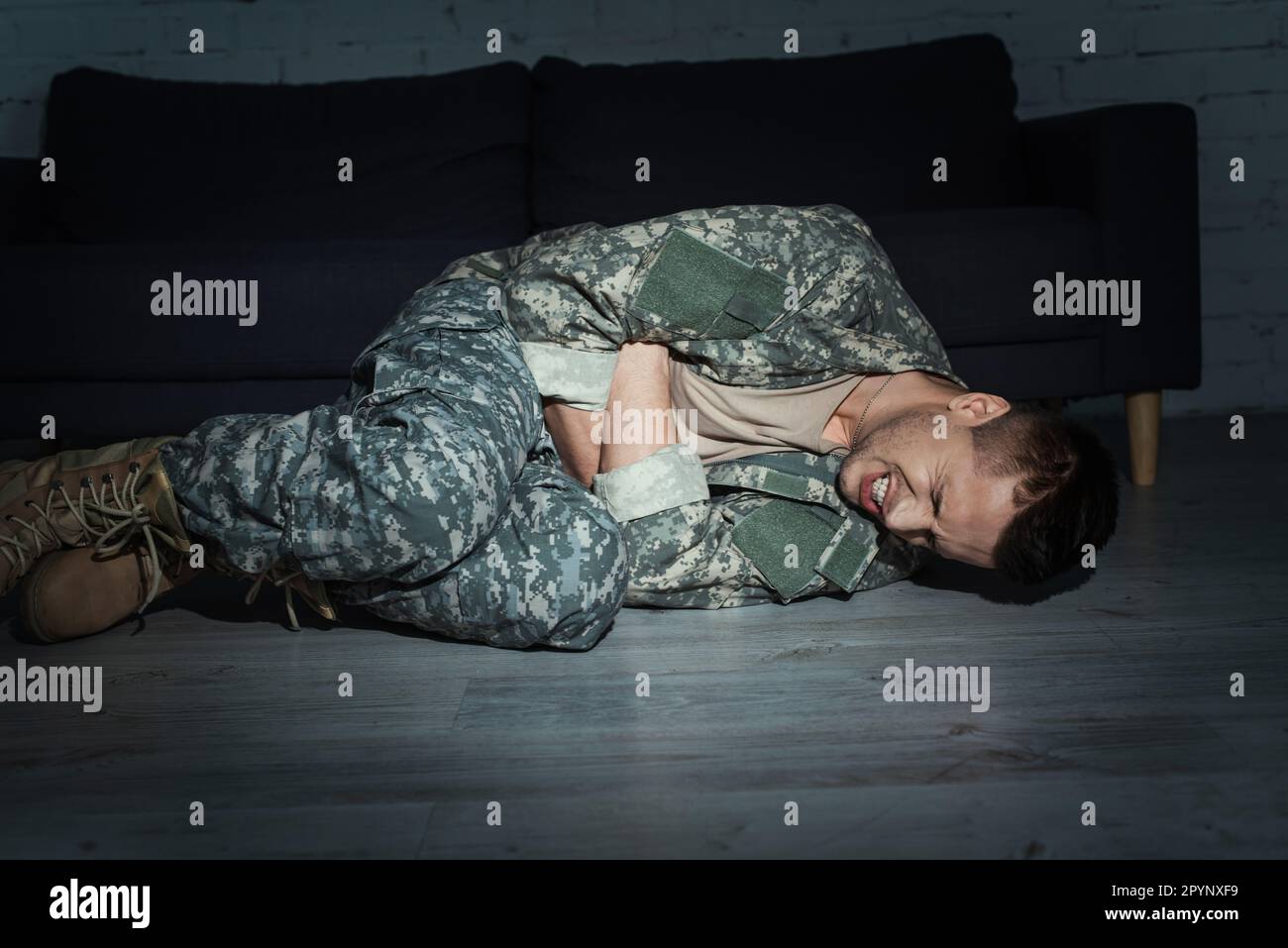 anxious serviceman in military uniform suffering from post traumatic ...