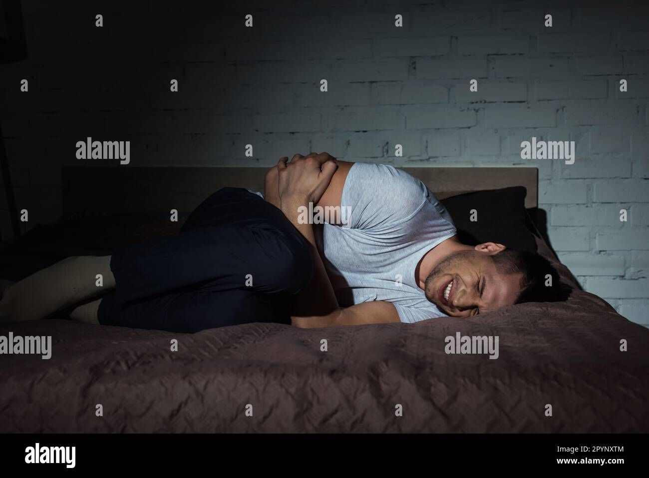 young man with closed eyes suffering from post traumatic stress ...