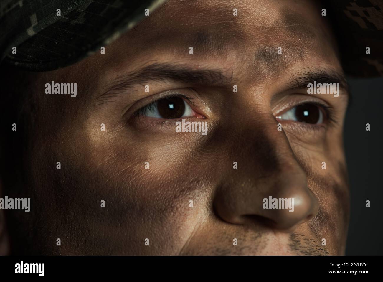 close up view of eyes of military man with dirt on face suffering from ...