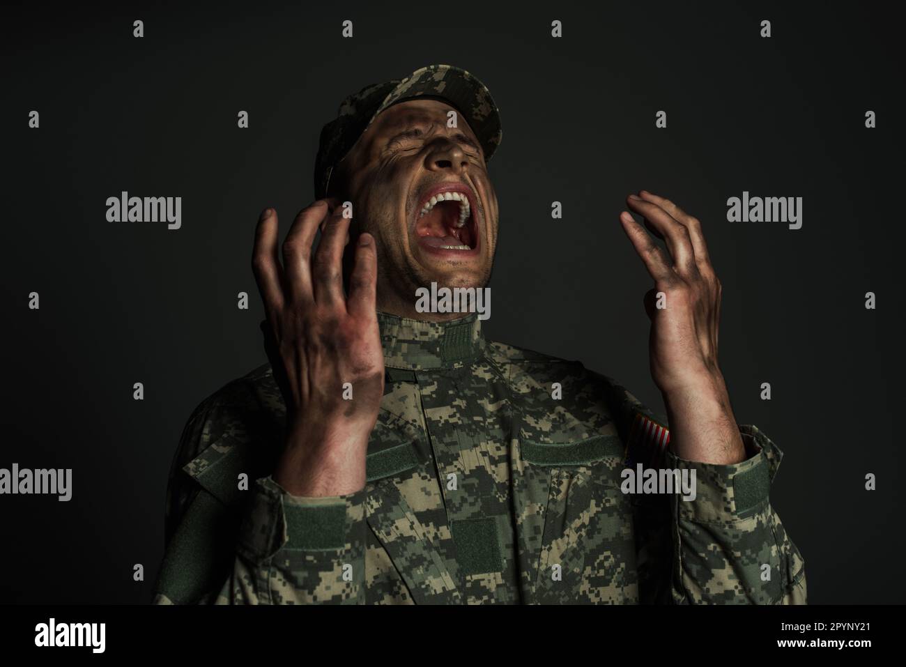 military man with dirt on face screaming while suffering from ptsd ...