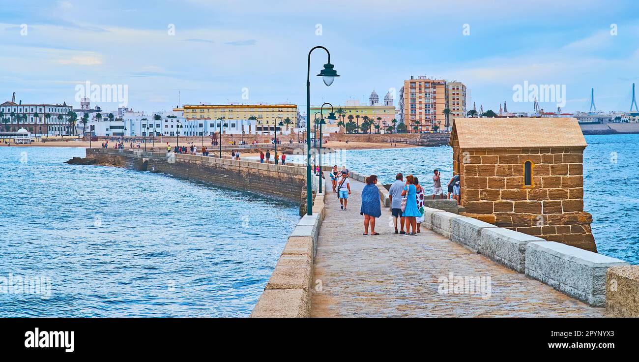 Panorama of the stone levee, watchhouse and waters of Bay of Cadiz ...