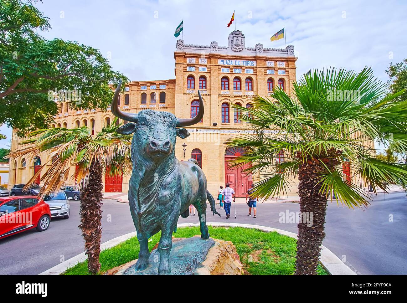 The bronze bull (El Toro) statue on Plaza de Toros against historic ...