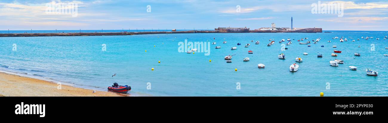 Panorama of Bay of Cadiz shore with moored small boats and dinghies in ...