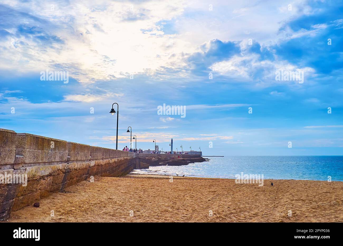 The long historic stone levee of San Sebastian Castle from the sand La Caleta beach, Cadiz ...