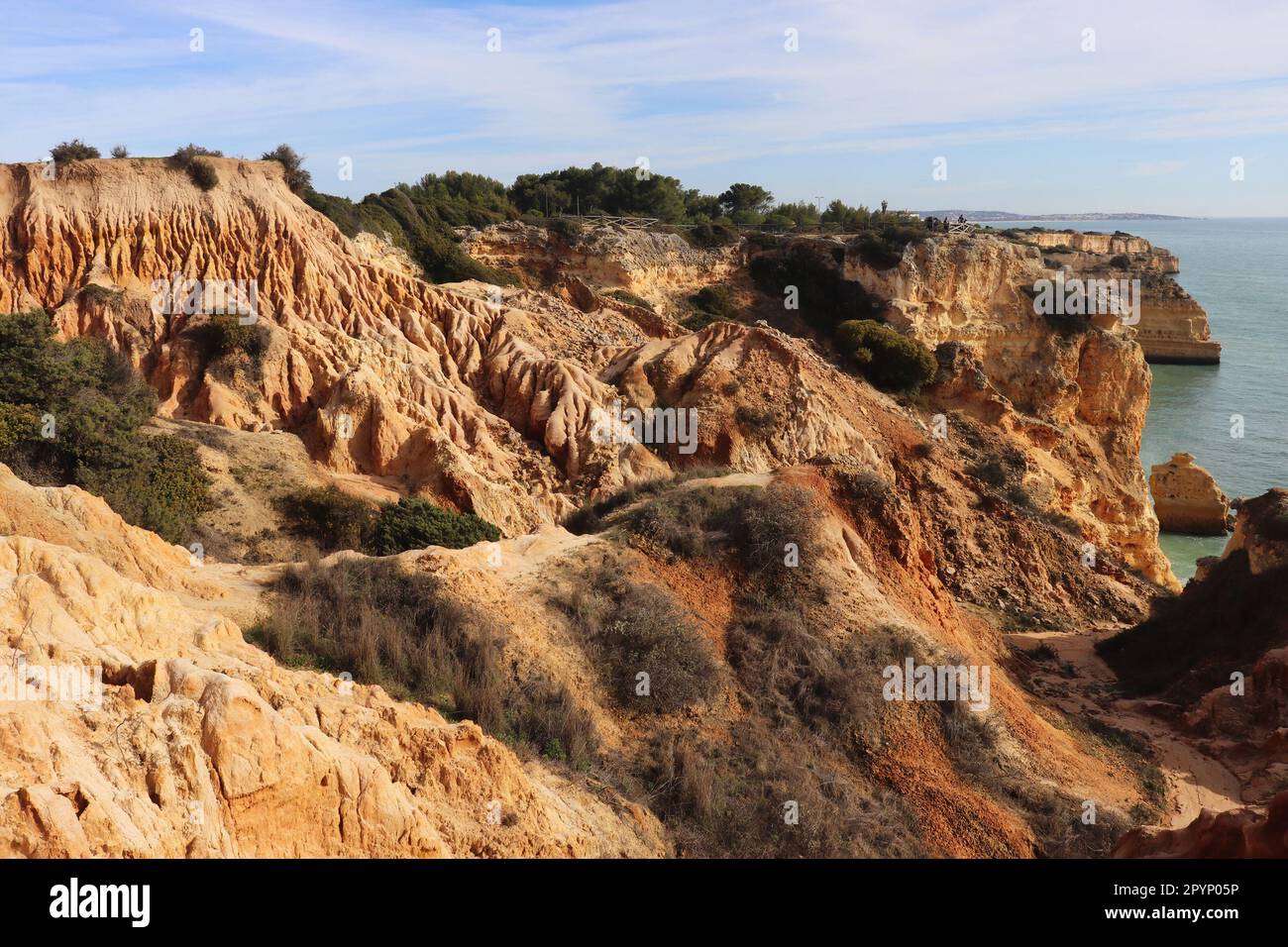 Orange limestone cliffs next to the Atlantic Ocean along the Seven ...