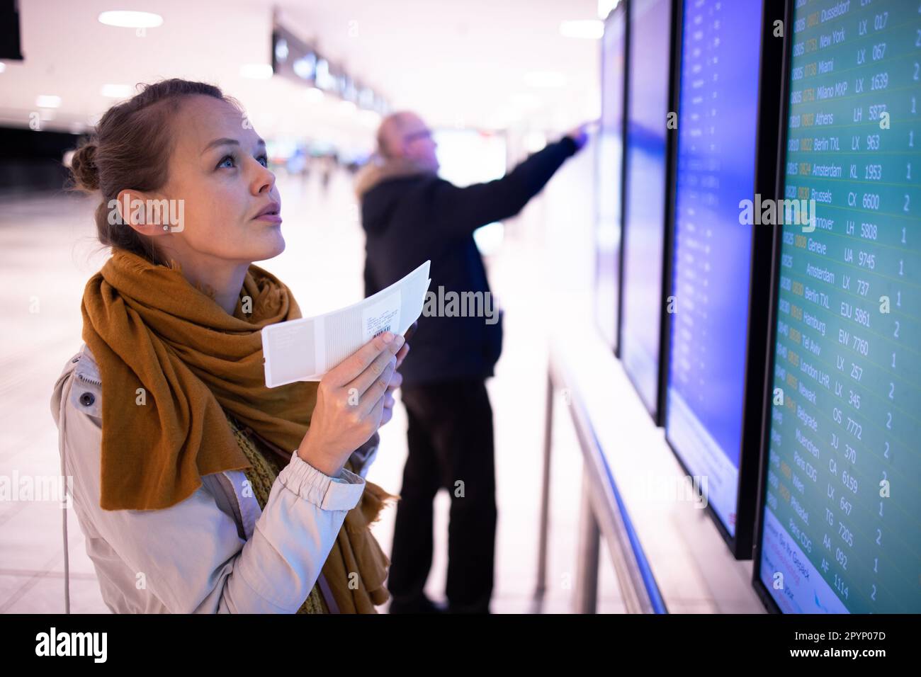 Canceled flight situation - Young, pretty female traveler learning ...