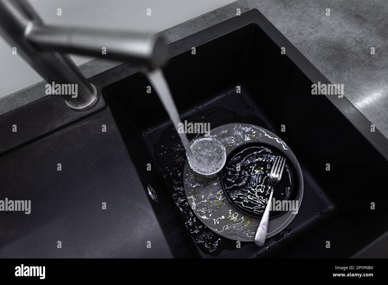 Kitchen sink with dishes and water running Stock Photo - Alamy