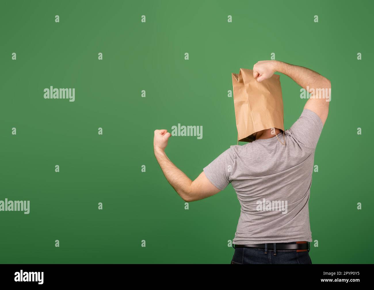 A man with a bag on his head, a dazed head demonstrates strength ...