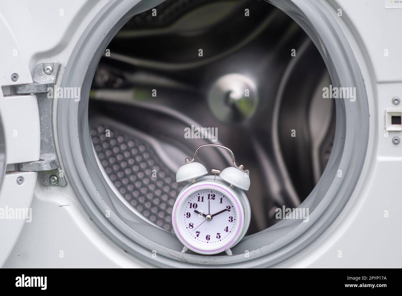 time and washing machine. Waiting, washing duration concept. Open door ...