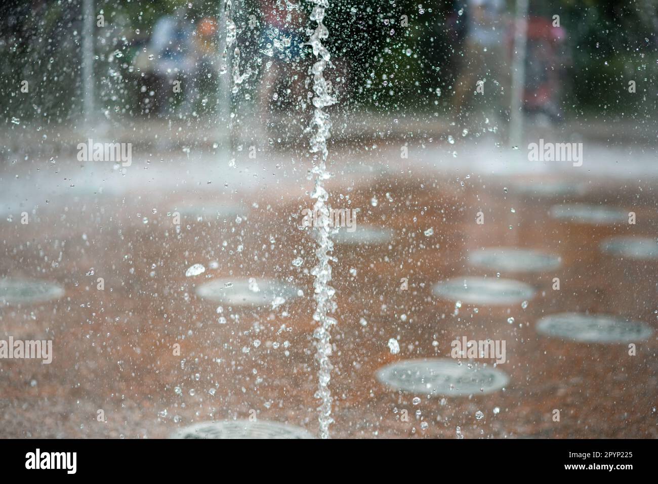 Fountain water jets rising from marble tiles Stock Photo - Alamy