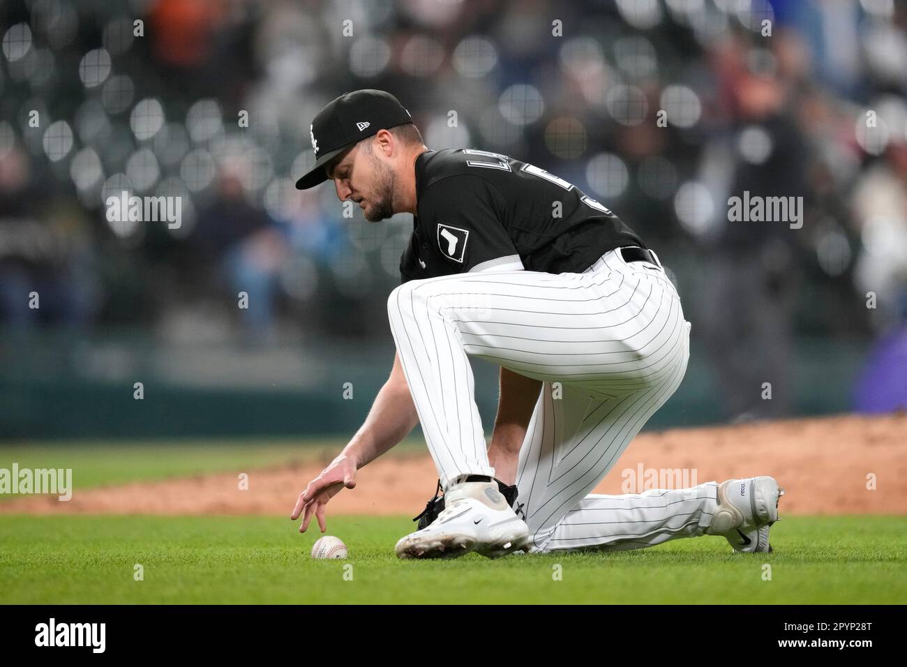Chicago White Sox relief pitcher Jimmy Lambert fields a ball in a ...
