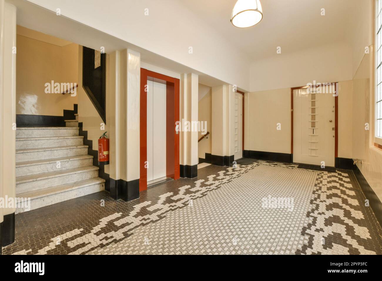 an empty room with tiled floor and red door in the middle, white walls ...