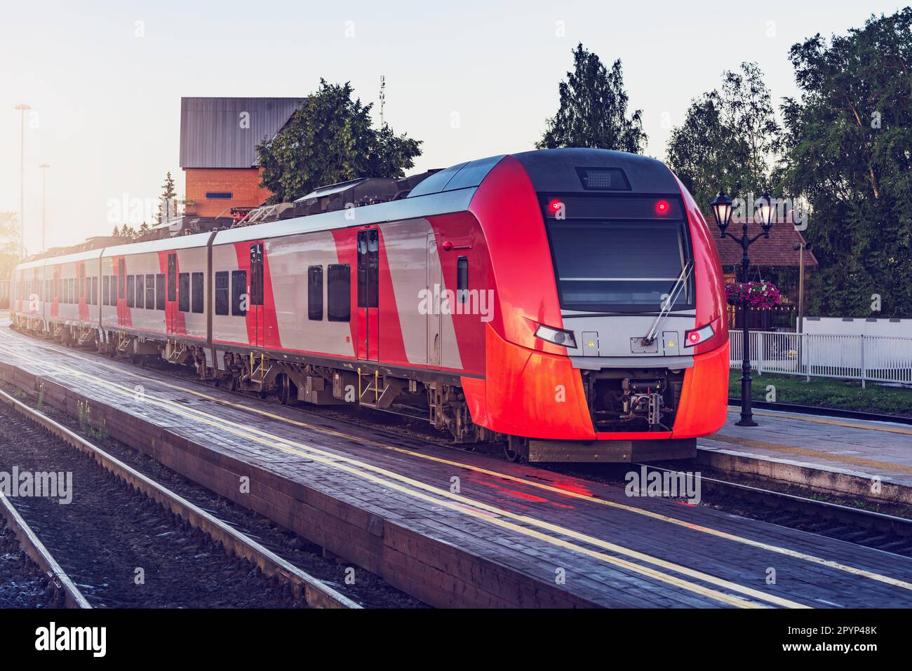 Train stands by the platform at sunrise time Stock Photo - Alamy