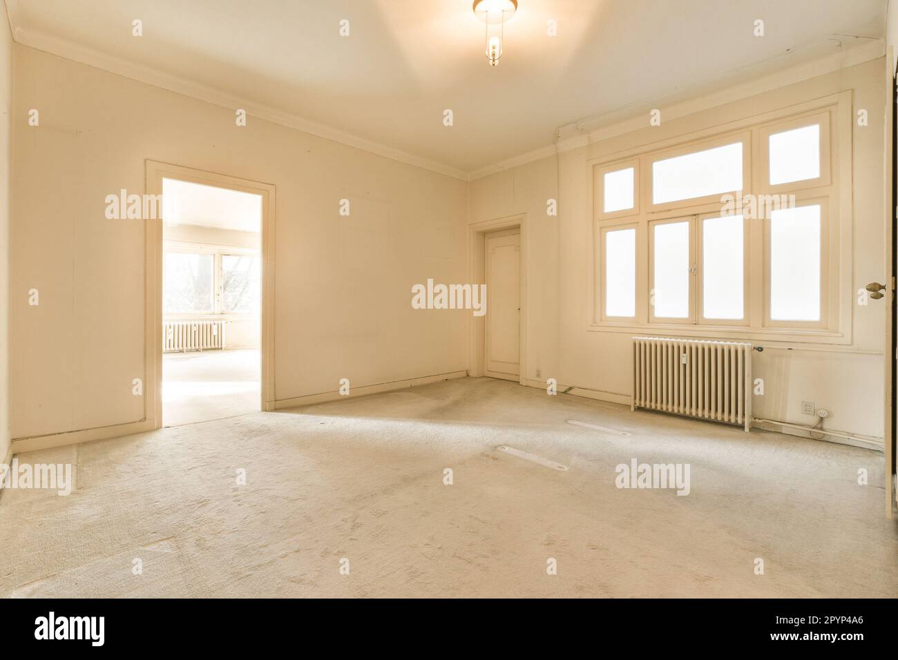 an empty room with light coming in through the window, and no one ...