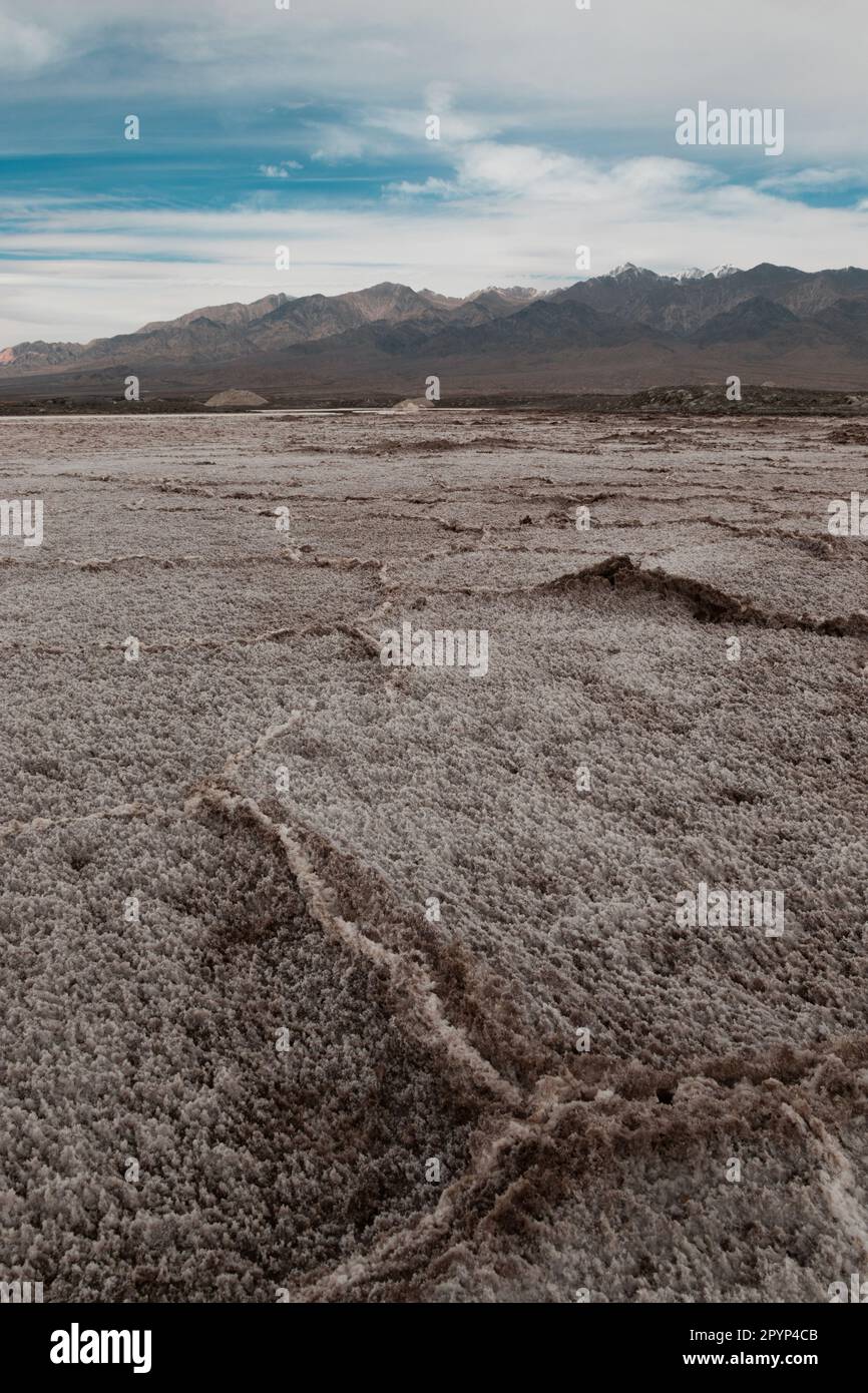A barren desert landscape with grey cloud-filled skies and distant ...