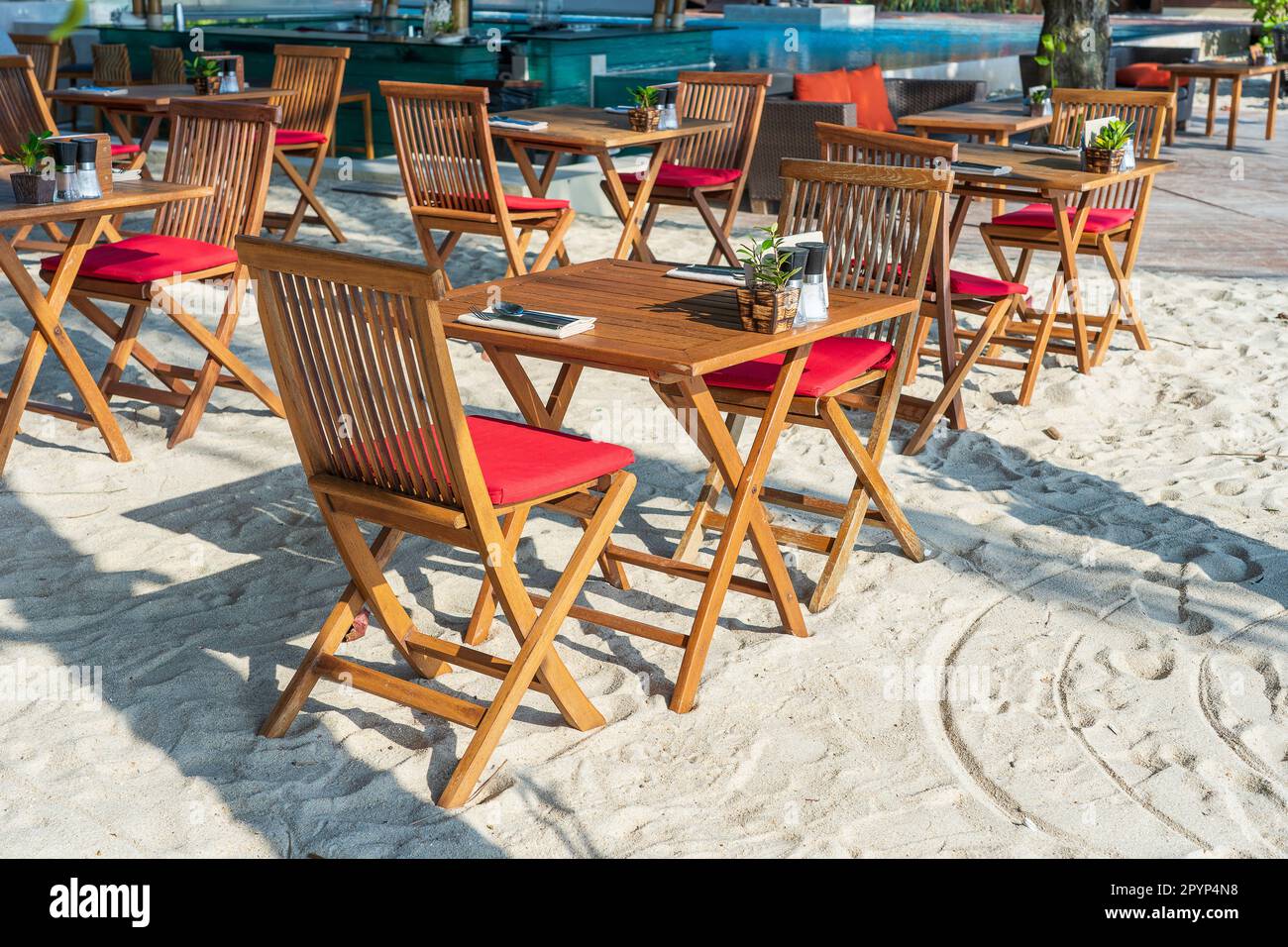 Wooden table and chairs in empty beach cafe next to sea. Close up. Island Koh Phangan, Thailand ...