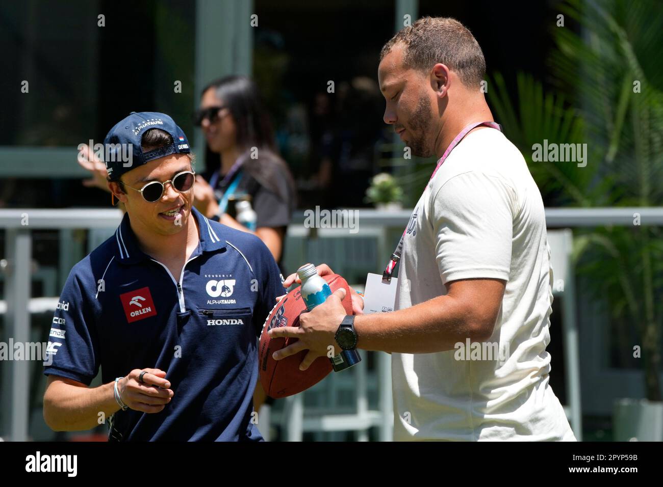 Miami Dolphins fullback Alec Ingold, right, teaches AlphaTauri driver ...