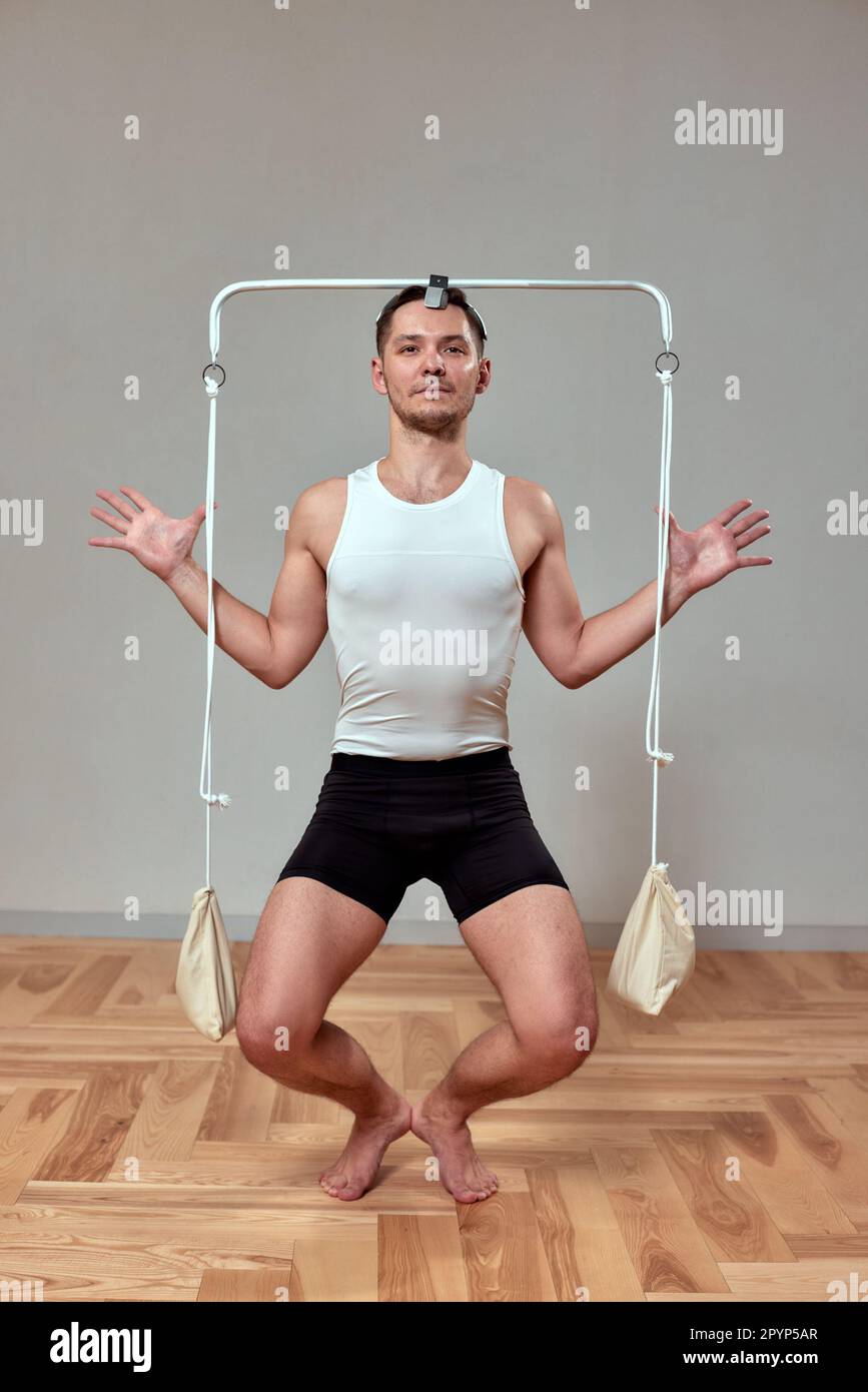 A man does exercises on a Pilates reformer, reformers for Pilates ...
