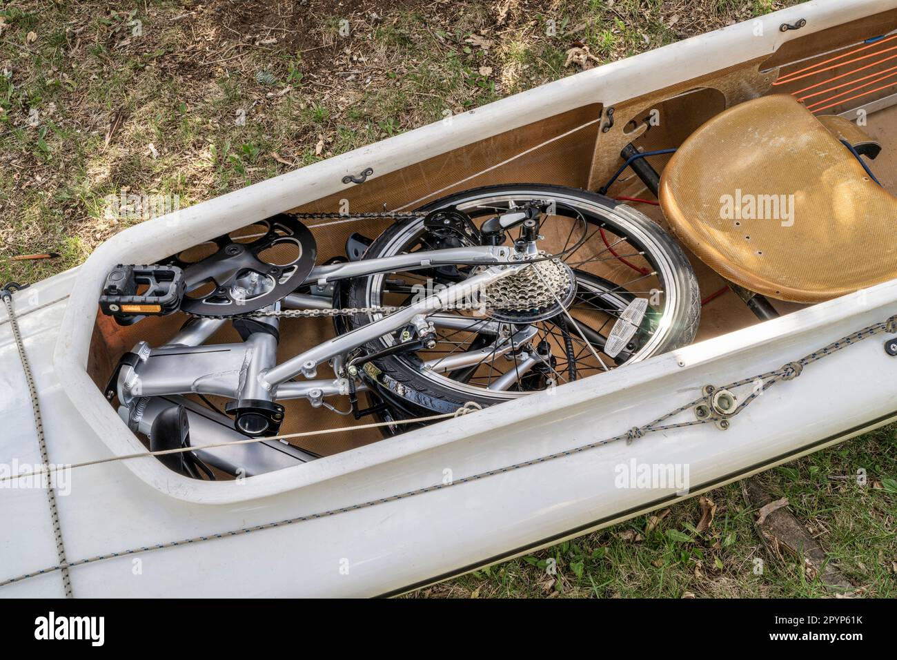 folding bike packed into a cockpit of expedition canoe Stock Photo - Alamy