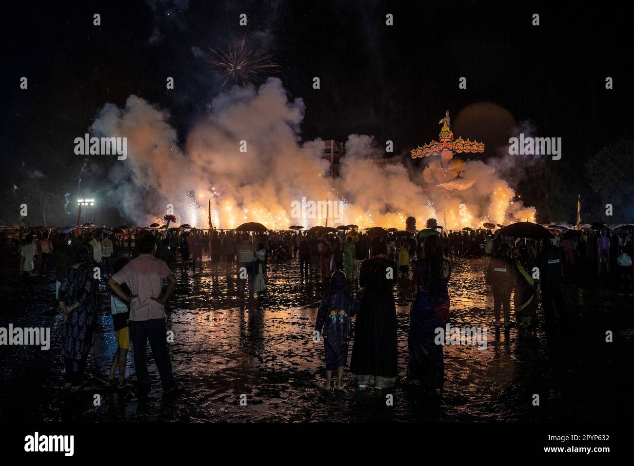 A crowd watches the burning of an effigy of Ravana during Dussehra ...