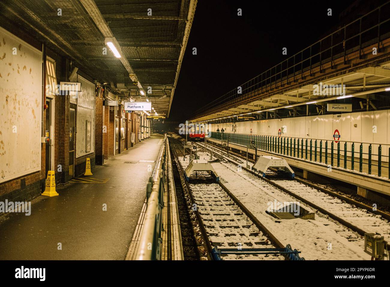 A close-up of an unmanned train pulling into a station on a set of ...