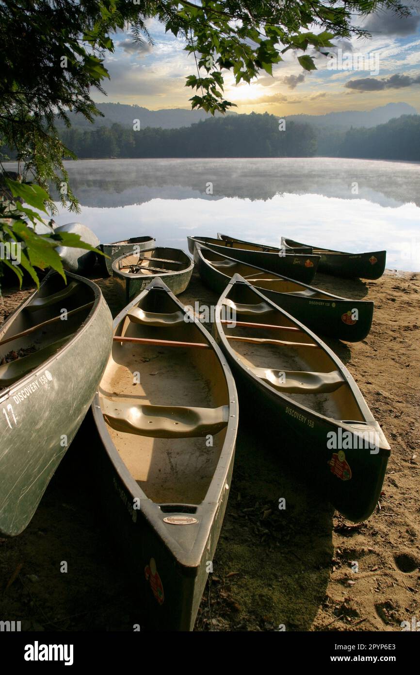 Canoes on the shore of lake in the Adirondack Mountains of New York ...