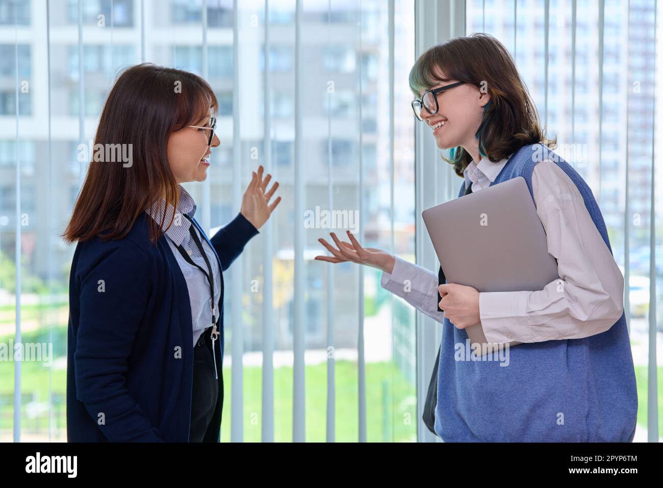 Meeting, conversation of female teacher and girl college student in ...