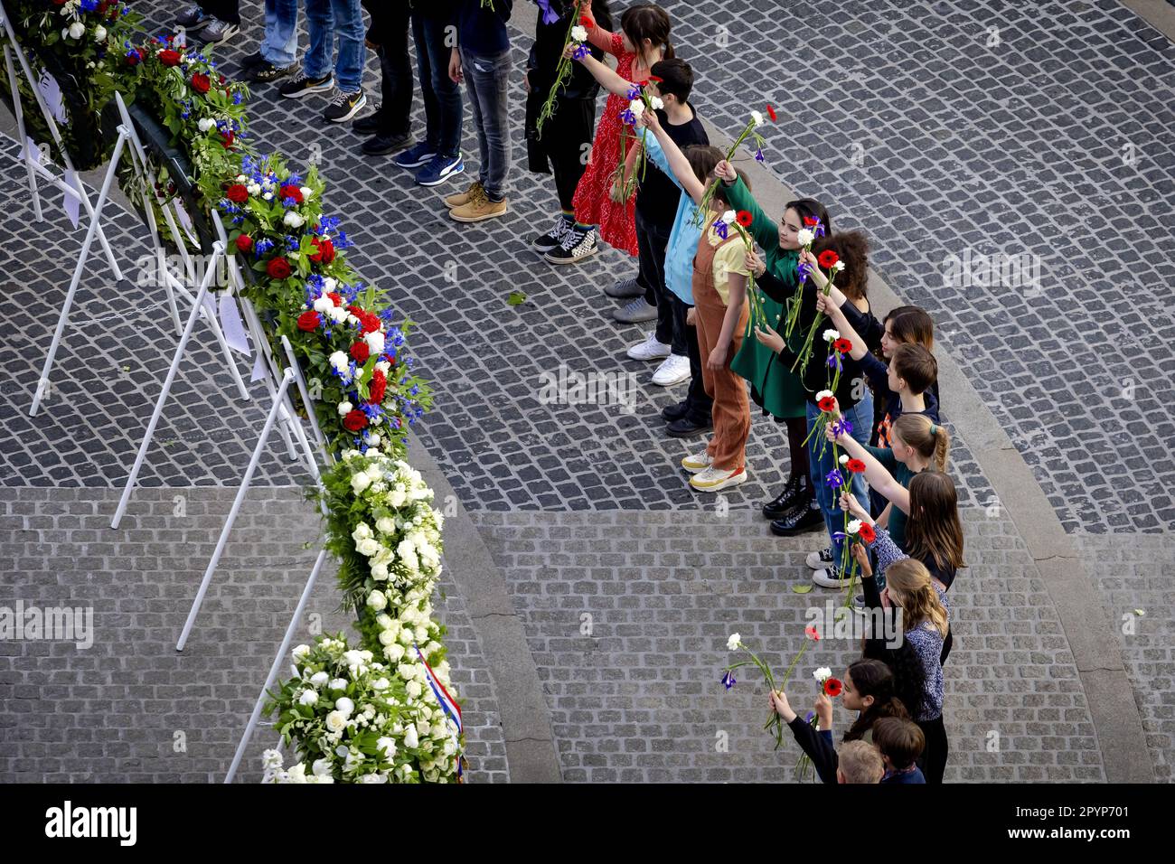 AMSTERDAM - Children lay a flower during the National Remembrance Day ...