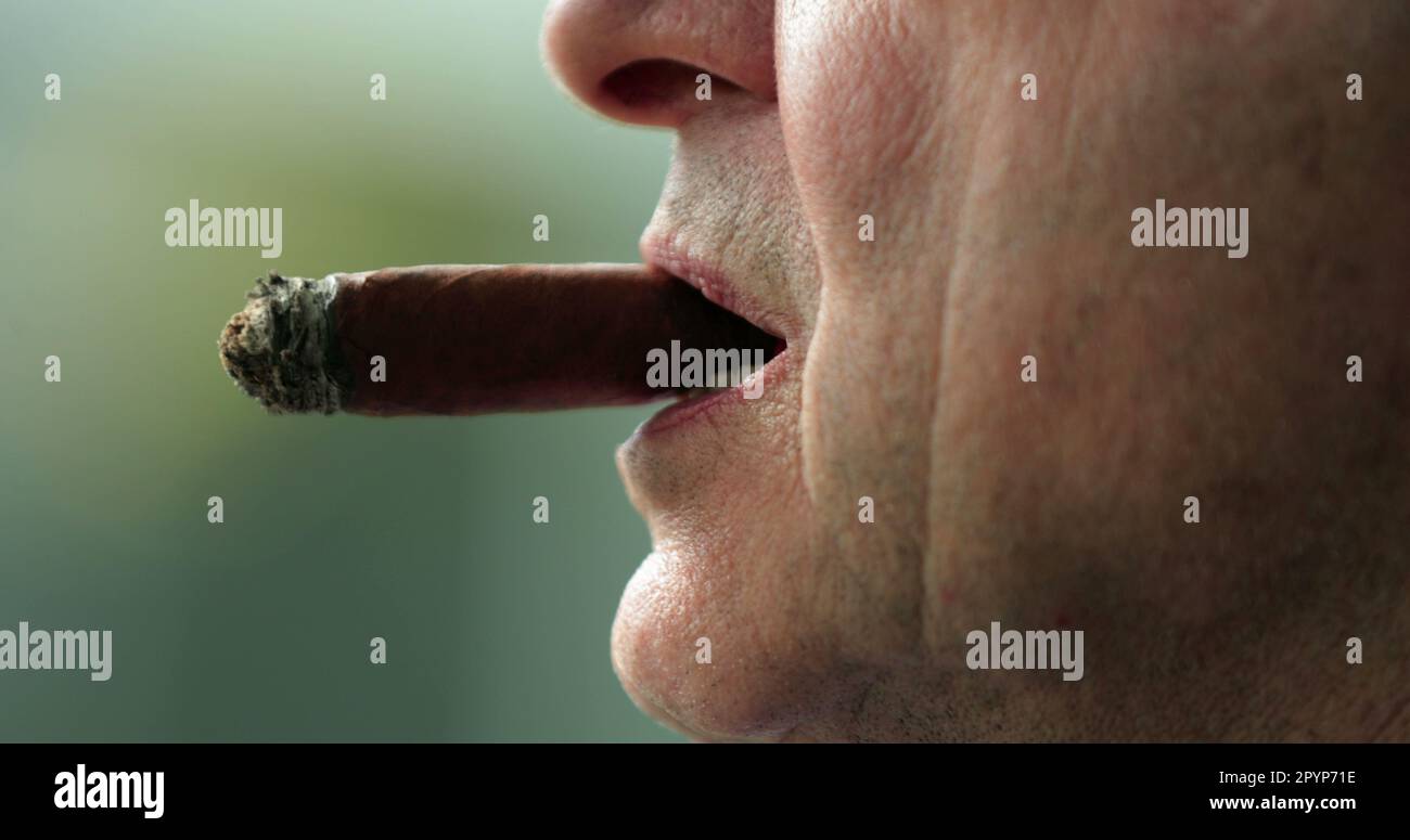 Man smoking cigar, close-up of older man mouth inhaling smoke Stock Photo - Alamy