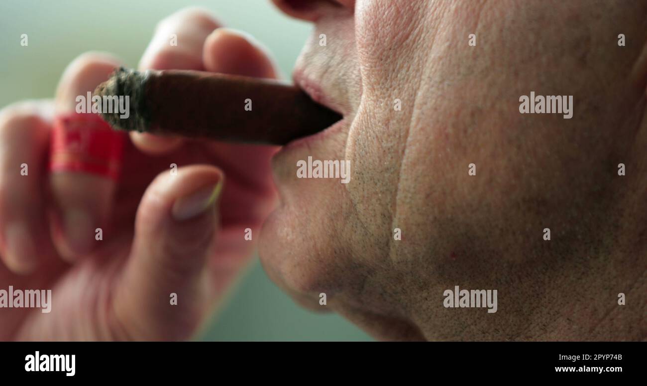 Man smoking cigar, close-up of older man mouth inhaling smoke Stock Photo - Alamy