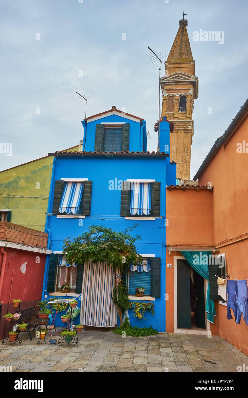 Blue facade of the house with door and windows. Colorful architecture ...