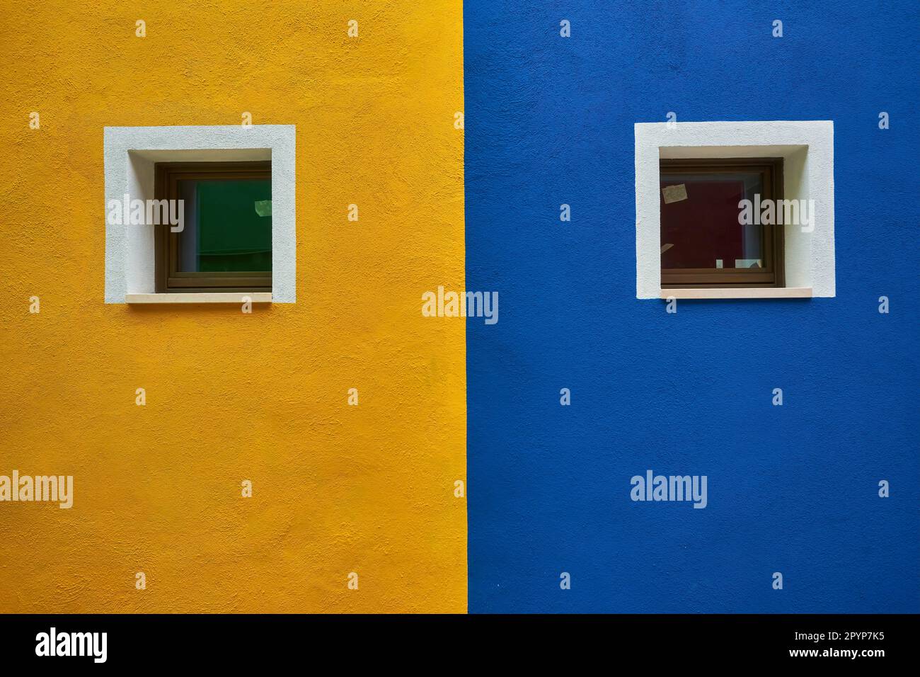 Beautiful colorful house facade on Burano island, north Italy. Half ...