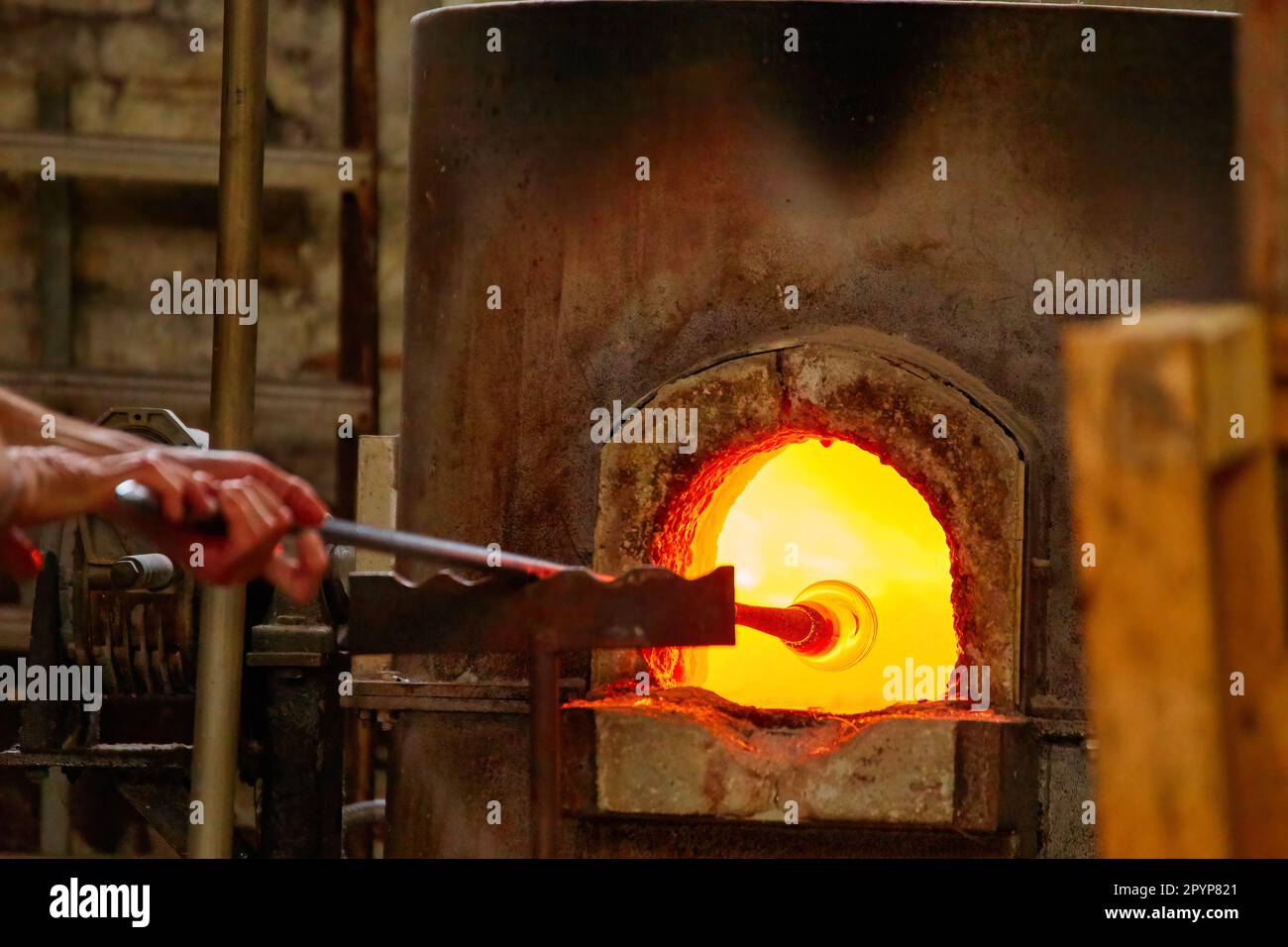 A Glass Blower Shaping Molten Glass into a Piece of Art Stock Photo - Alamy