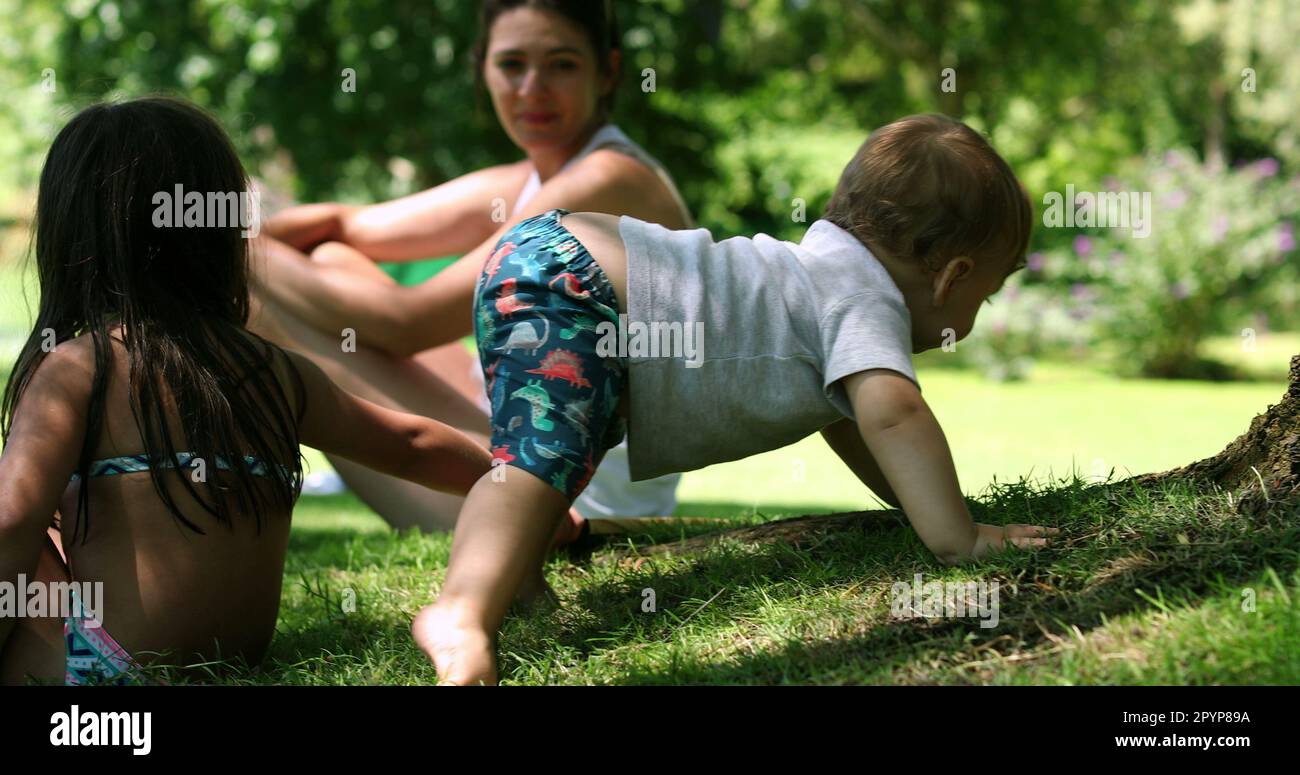 Cute baby discovering lawn. Adorable toddler infant exploring garden ...