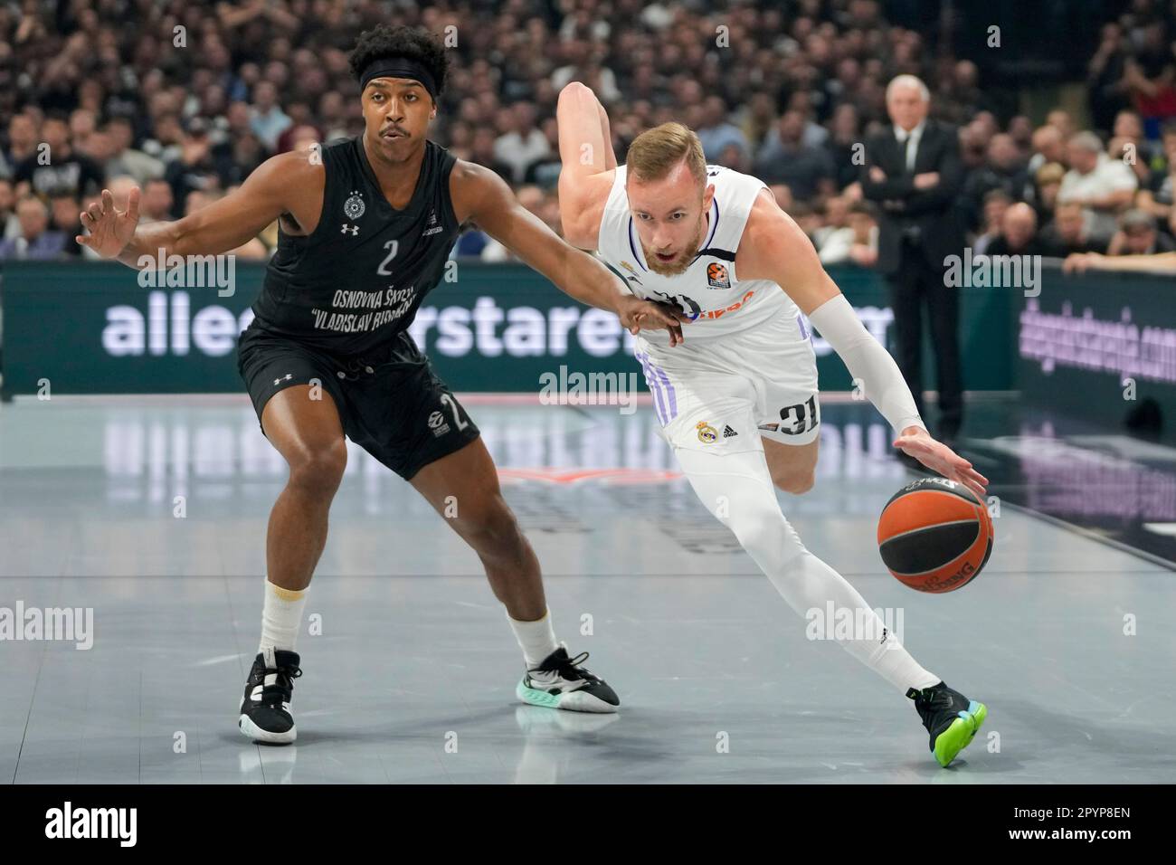Real Madrid's Dzanan Musa, right, drives to the basket as Partizan's ...