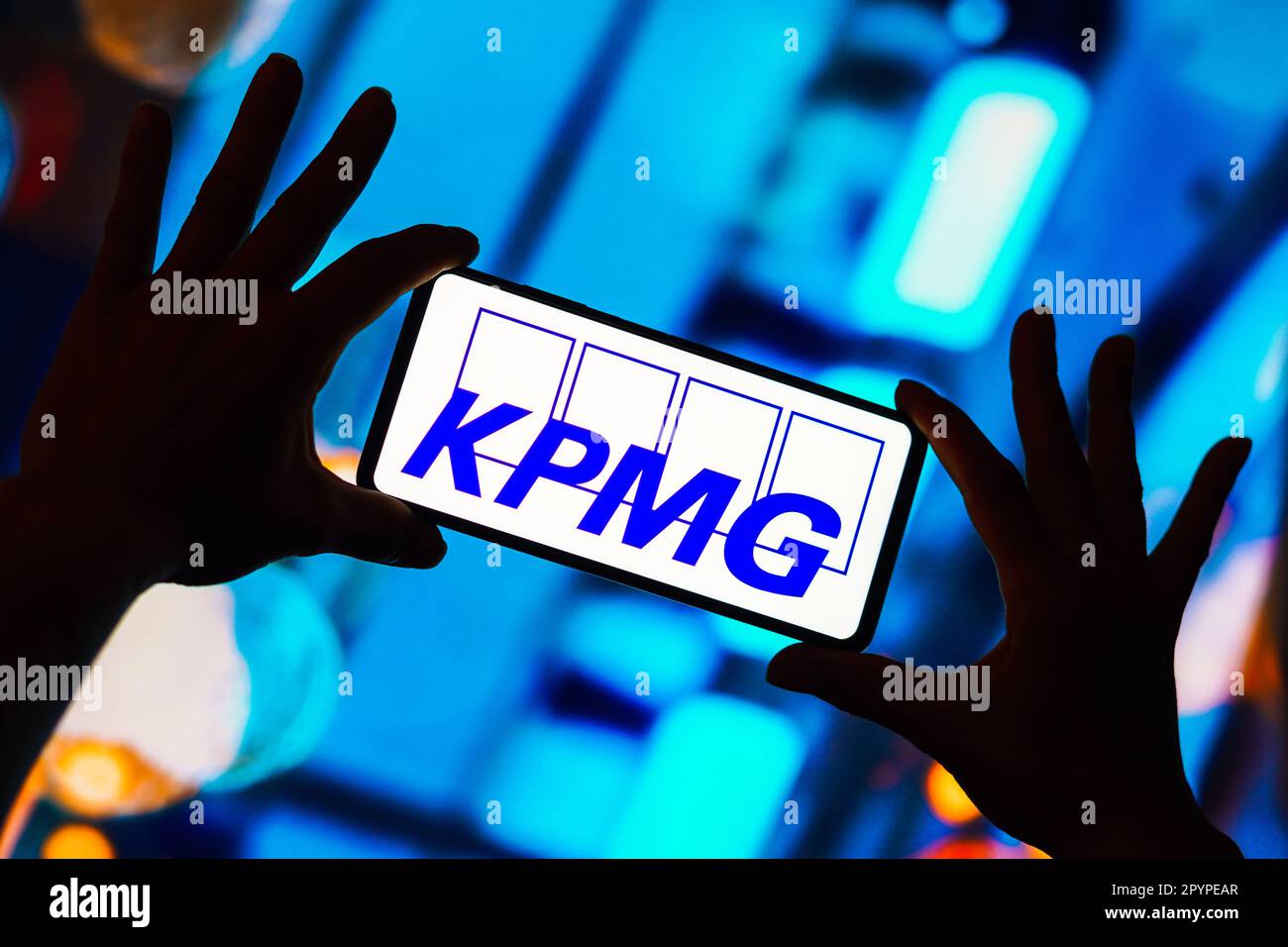 In this photo illustration, the KPMG logo is displayed on a smartphone ...