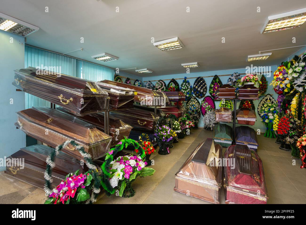 Interior of room with funeral accessories. Shop selling coffins ...
