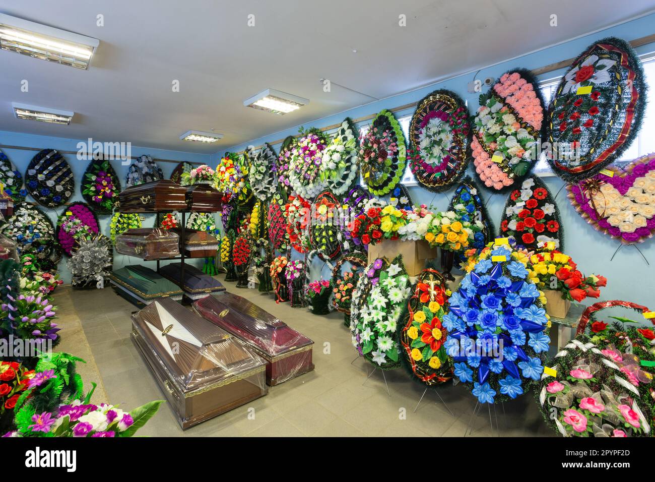 Interior of room with funeral accessories. Shop selling coffins ...