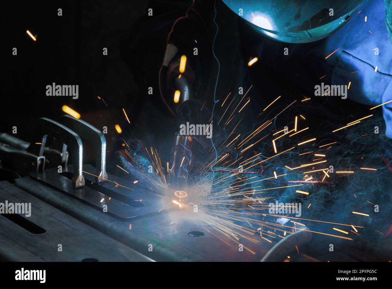 This workplace where worker is welding steel at work spark lighting ...