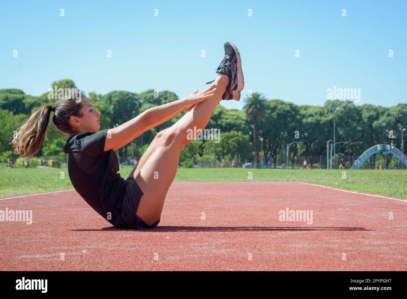 young latin woman of argentinian ethnicity, training abdominal muscles ...