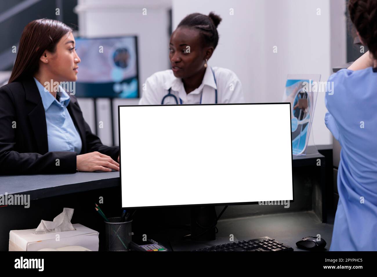 Computer with white screen standing on reception counter desk in ...